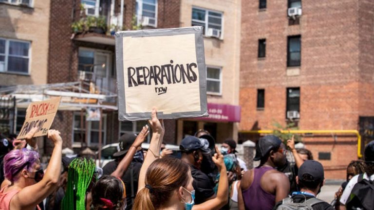 reparations-now-sign-910x512 - Institute of the Black World 21st Century